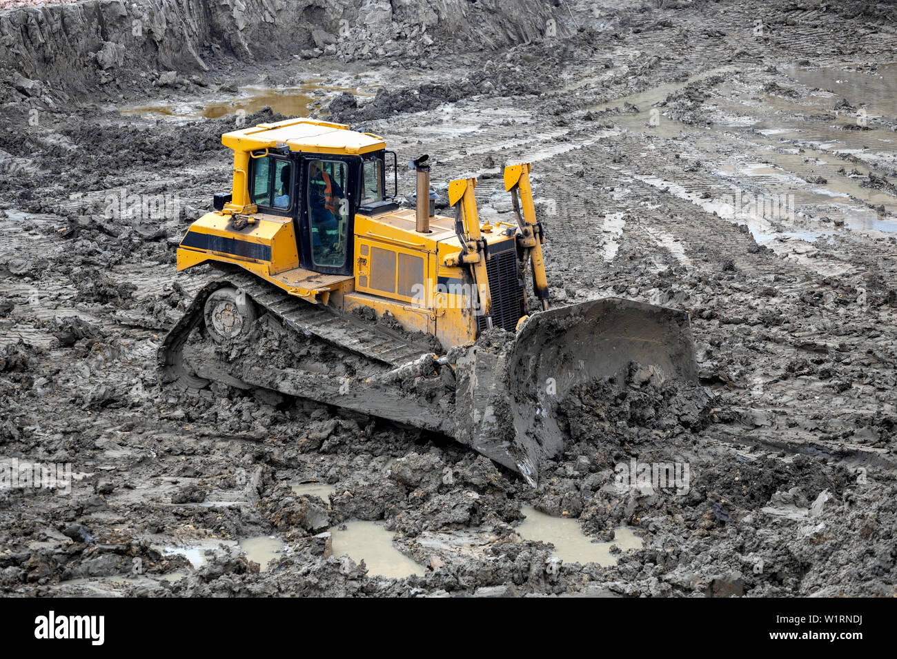 Push dirt with a dozer. Bulldozer working working at construction site ...