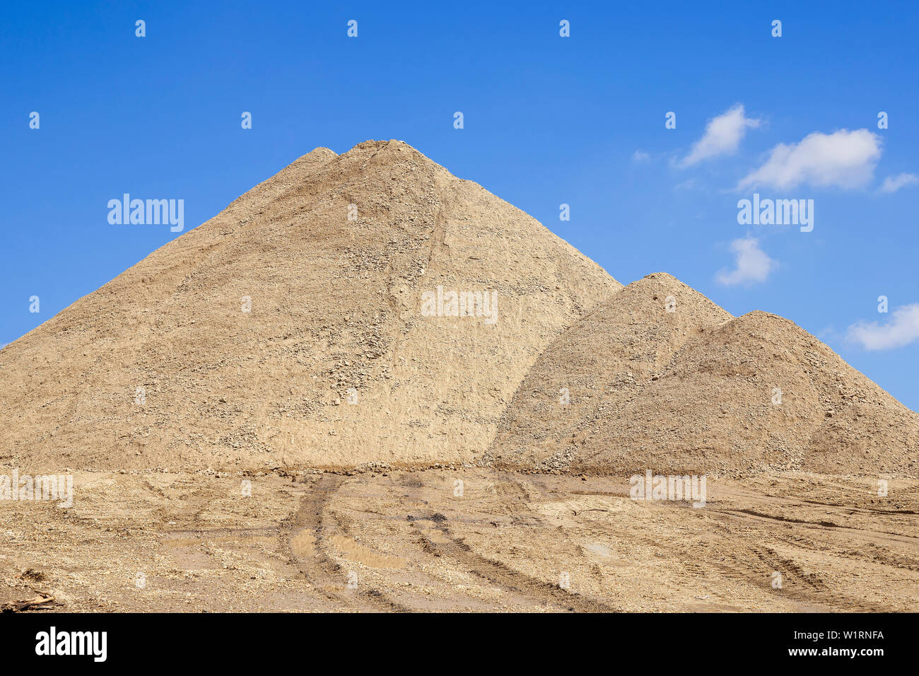 Large heap of construction sand for cement use in construction. River ...