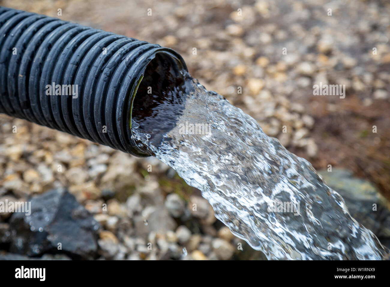 Stream of clean water from deep well without electricity. Cool and ...
