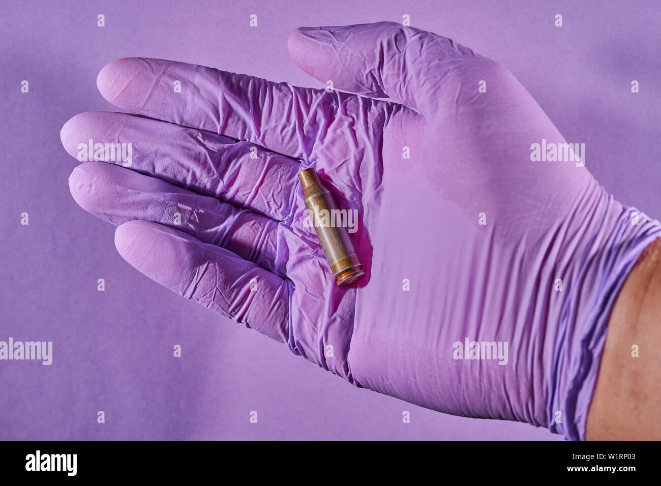 Glove holding bullet hi-res stock photography and images - Alamy