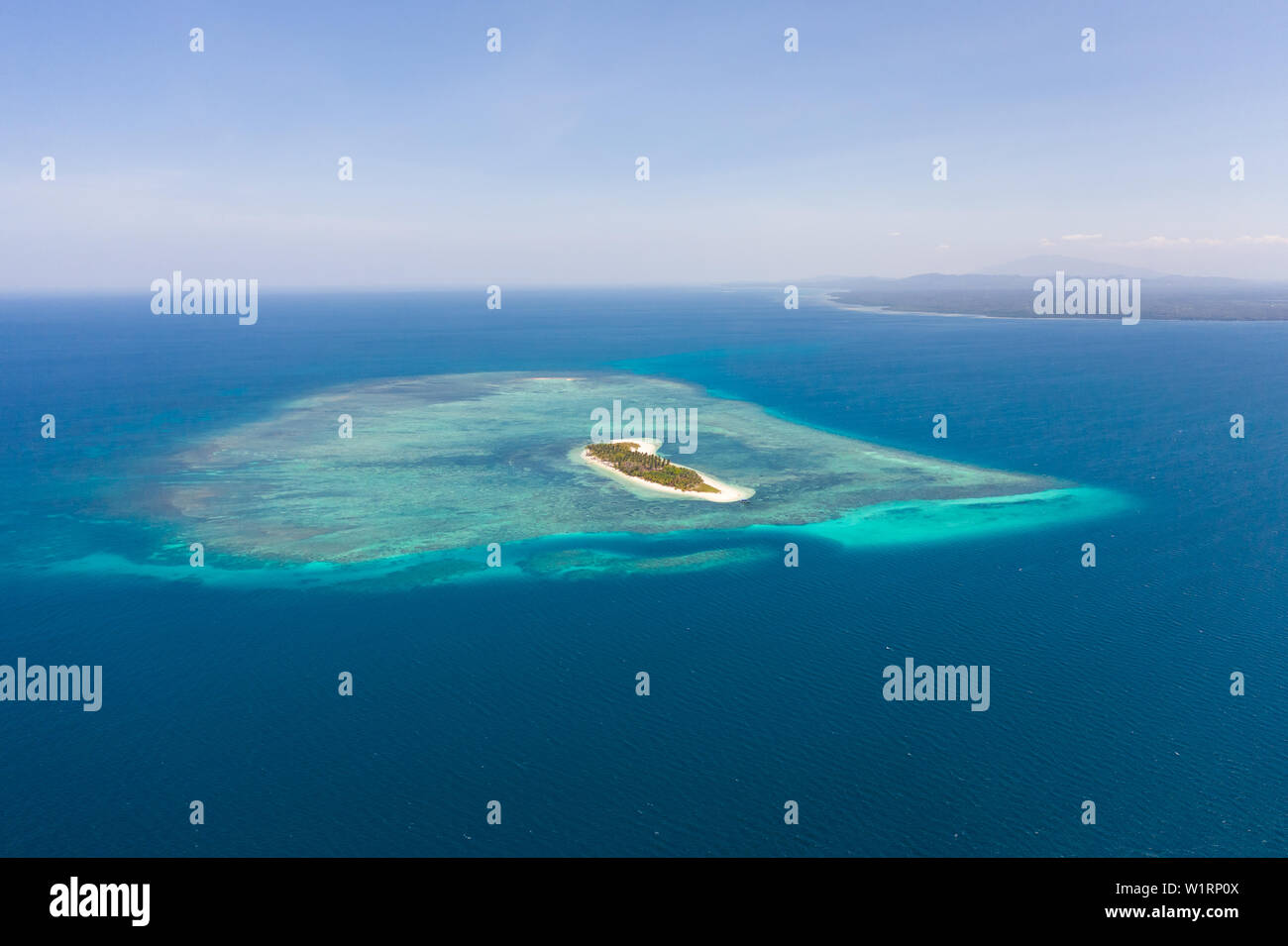Tropical island Canimeran with sandy beach in the blue sea with coral ...