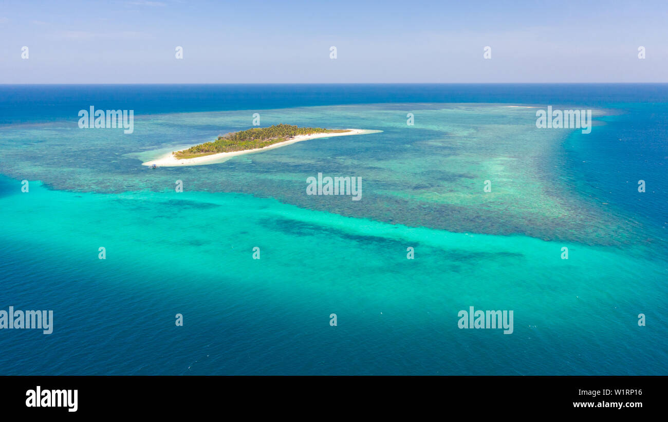 Tropical island Canimeran with sandy beach in the blue sea with coral ...