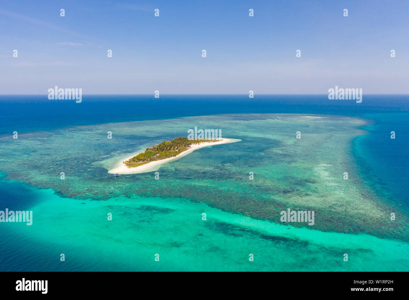 Tropical island Canimeran with sandy beach in the blue sea with coral ...
