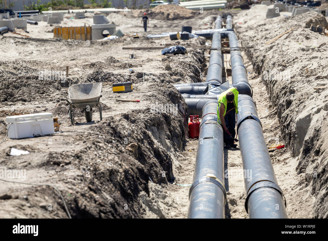 Laying pipeline for heating system. Underground heating system at a ...