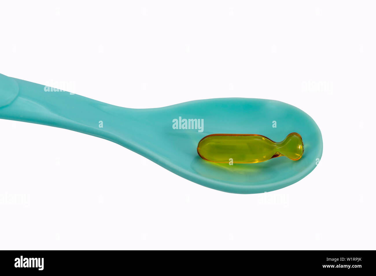 Vitamin D3 and K1 twist-off capsule in teaspoon remedy Stock Photo - Alamy