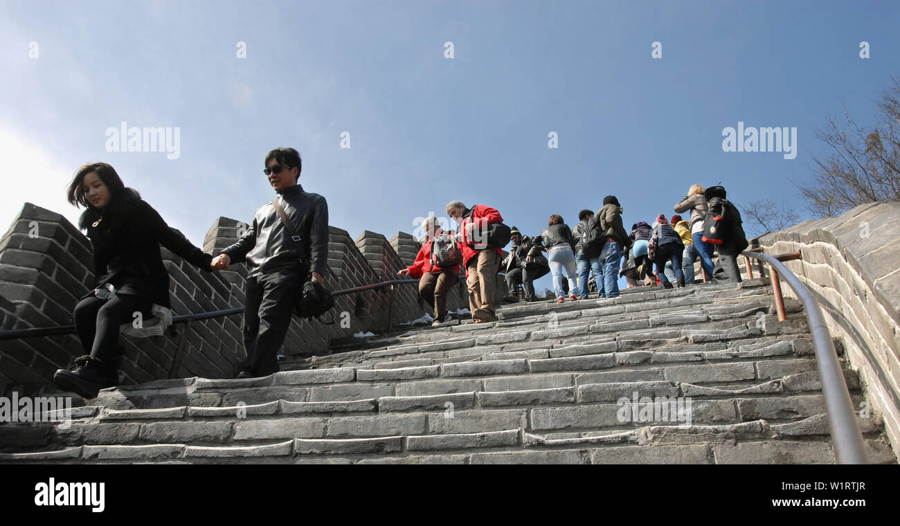 Great Wall of China at Juyongguan Beijing. Visitors walk on a steep ...