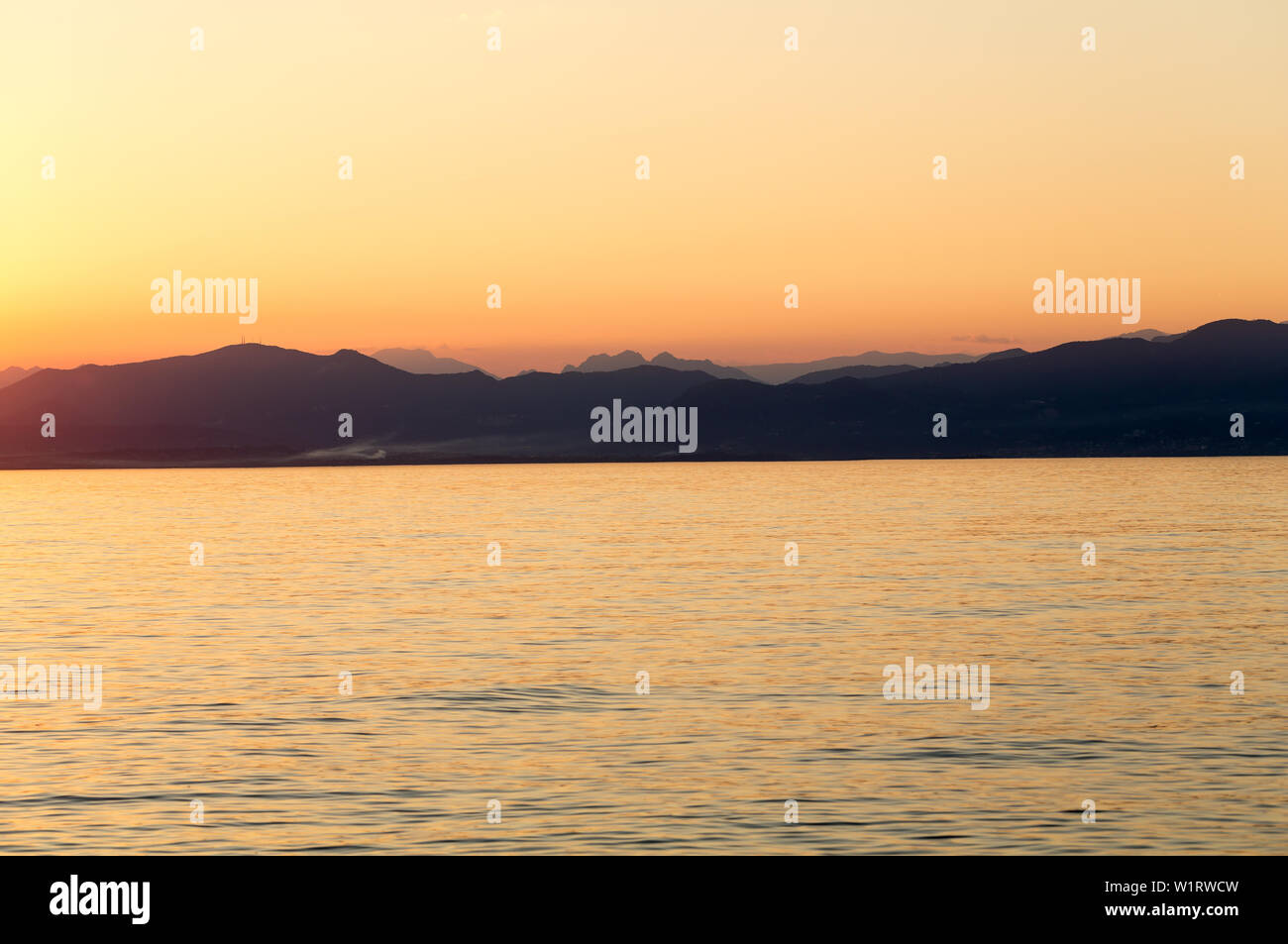 Beautiful sunset at Garda lake in Italy Stock Photo - Alamy