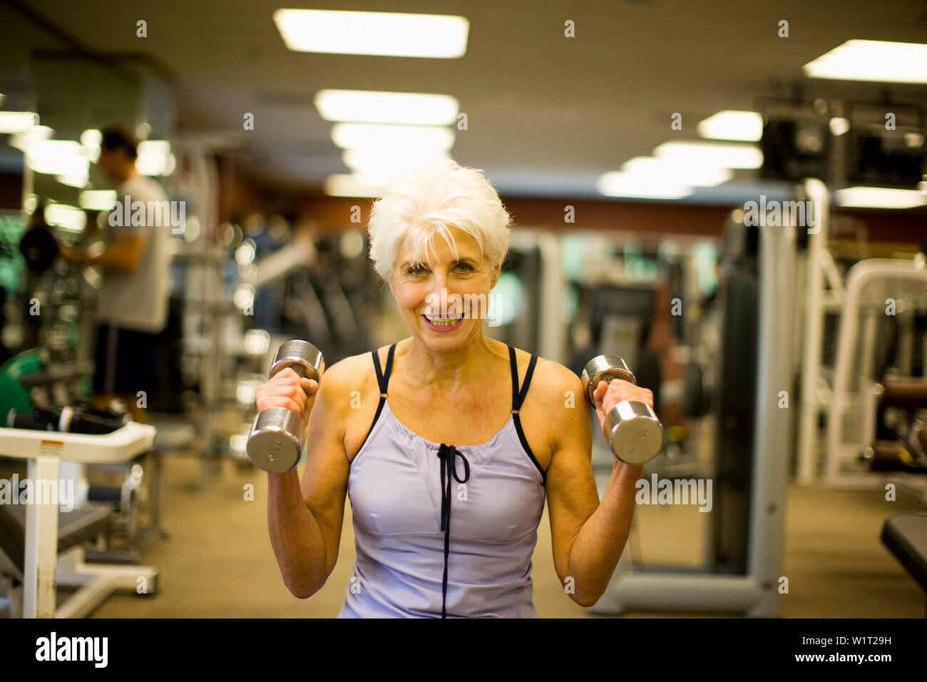 Smiling mature woman working out at the gym Stock Photo - Alamy