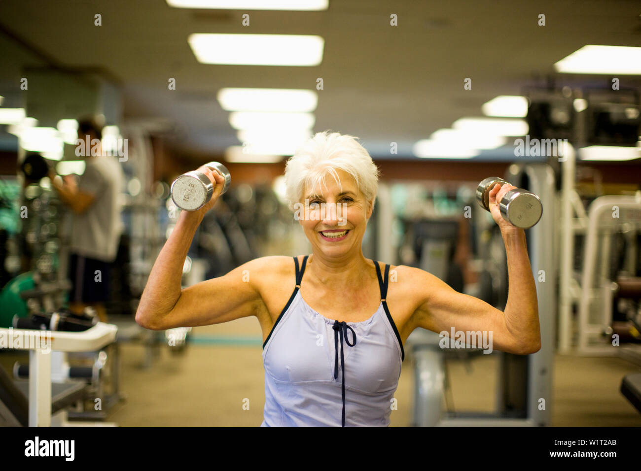 Smiling mature woman working out at the gym Stock Photo - Alamy