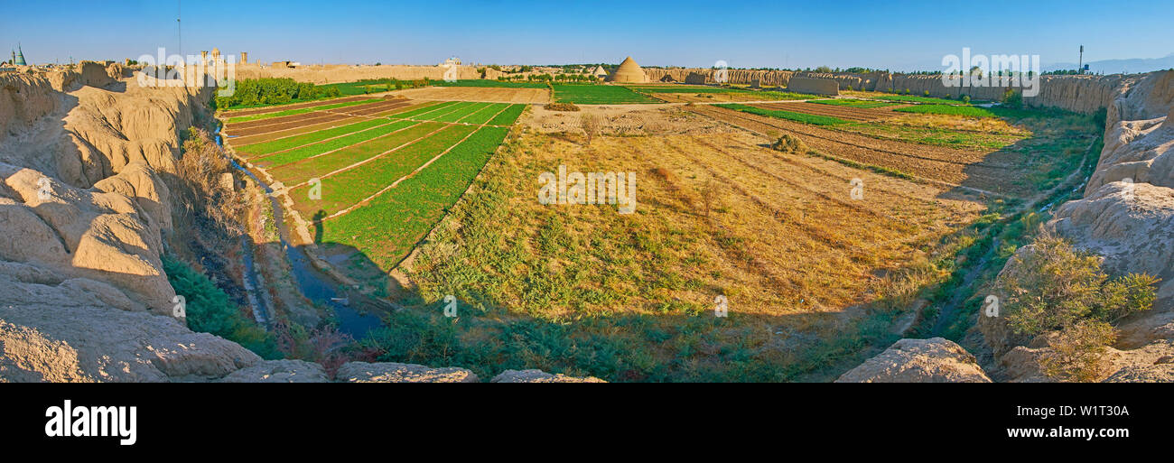Panorama of farm lands, surrounded by medieval adobe rampart of Ghaleh ...