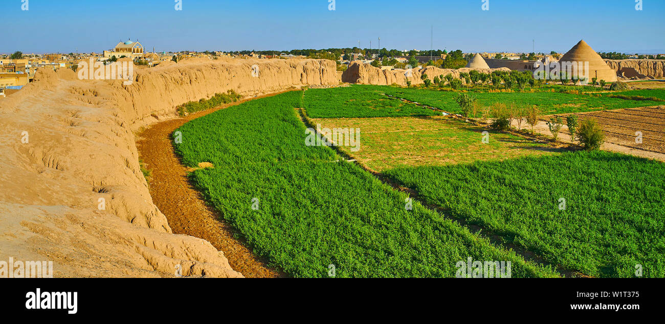 The ruins of adobe Ghaleh Jalali citadel with agricultural lands inside ...