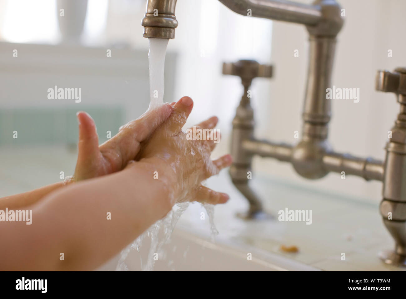 Child washing hands under tap Stock Photo - Alamy