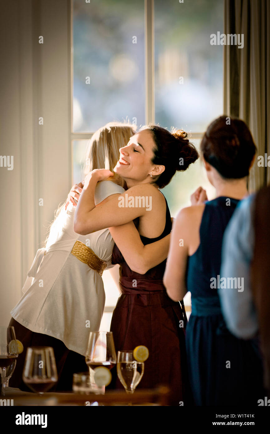 Friends hugging at a party Stock Photo - Alamy