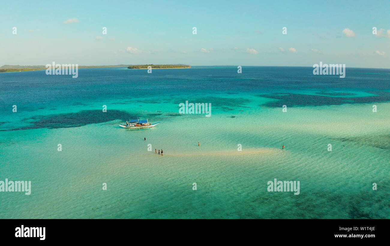 Sand bar among coral reefs in turquoise atoll water, top view. Summer ...