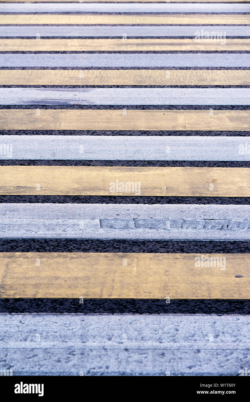 Pedestrian crossing. Road markings on asphalt. Striped blue and yellow ...