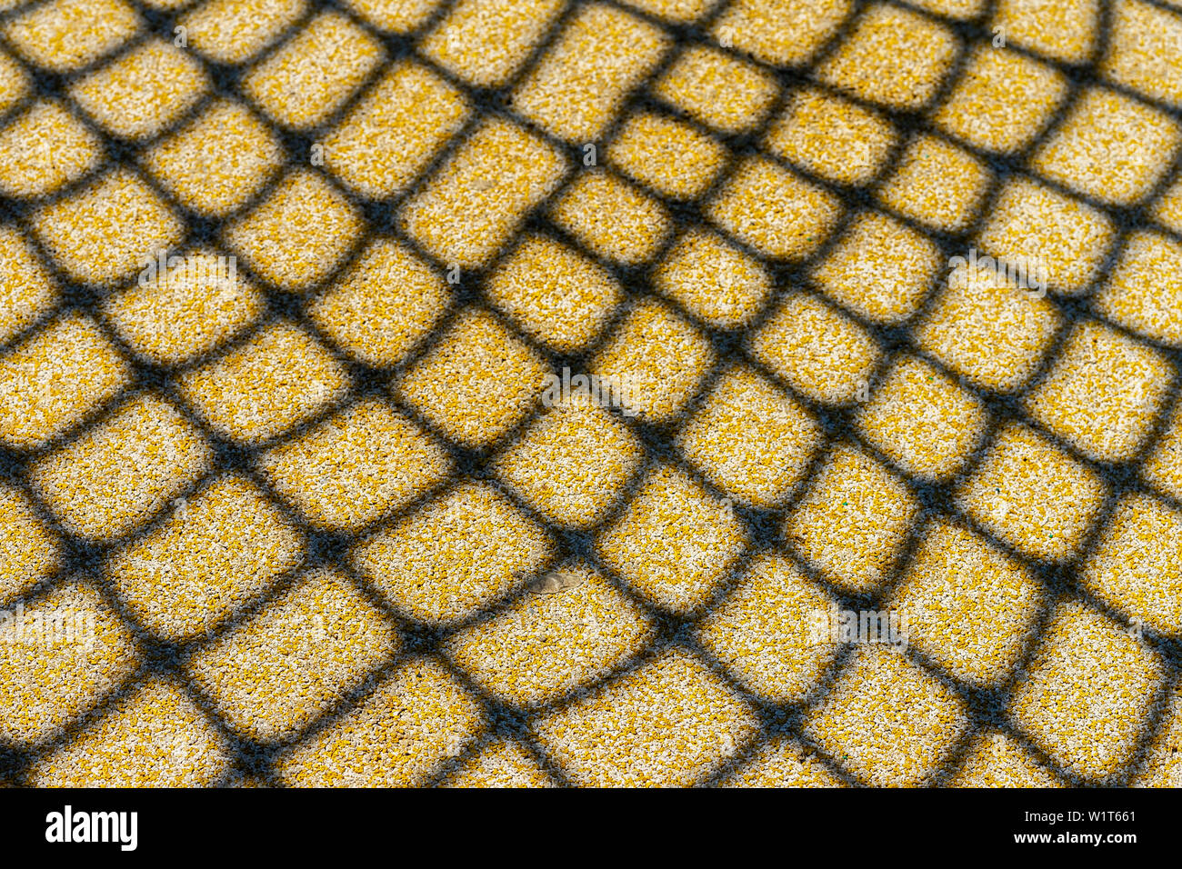 grid shadow on the sand. Background and texture Stock Photo - Alamy