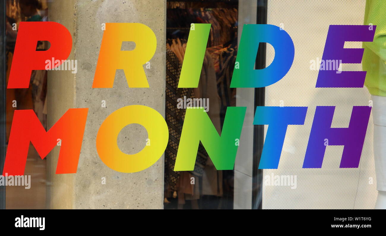 Rainbow coloured Pride Month store sign displayed on a window.Many ...