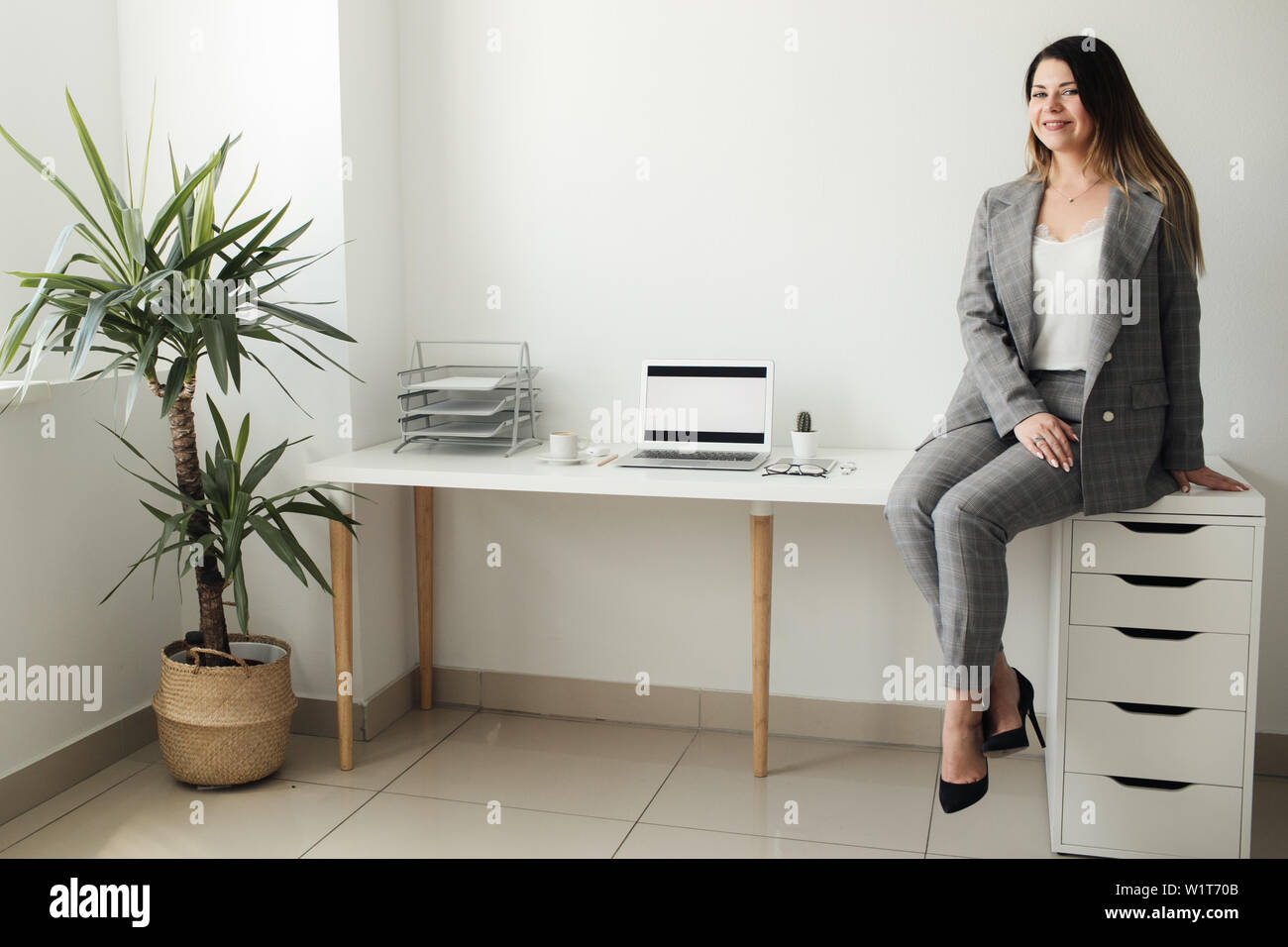 younger girl working in the office at the table Stock Photo - Alamy