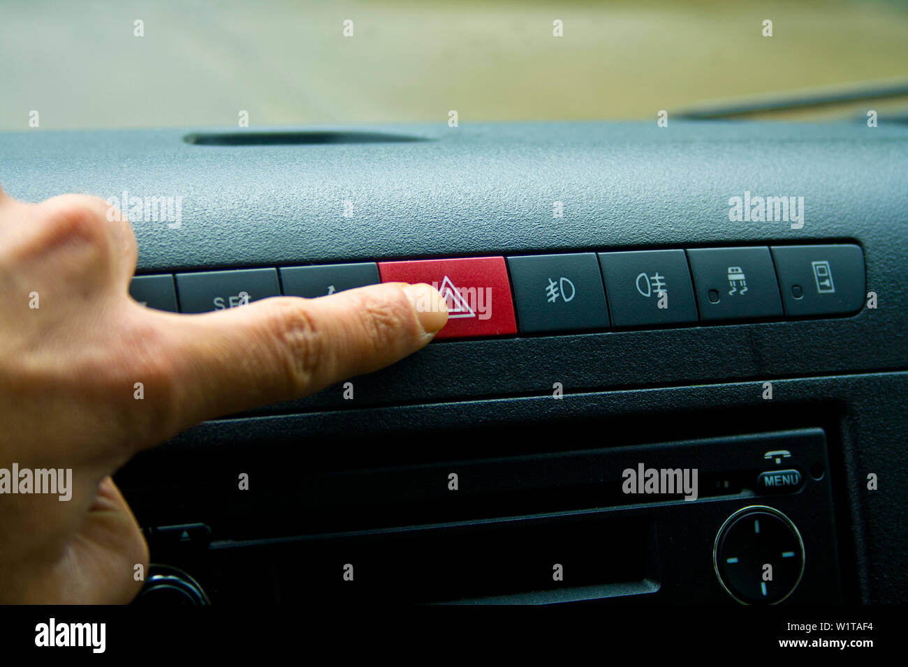 Finger hitting car emergency red light button Stock Photo - Alamy