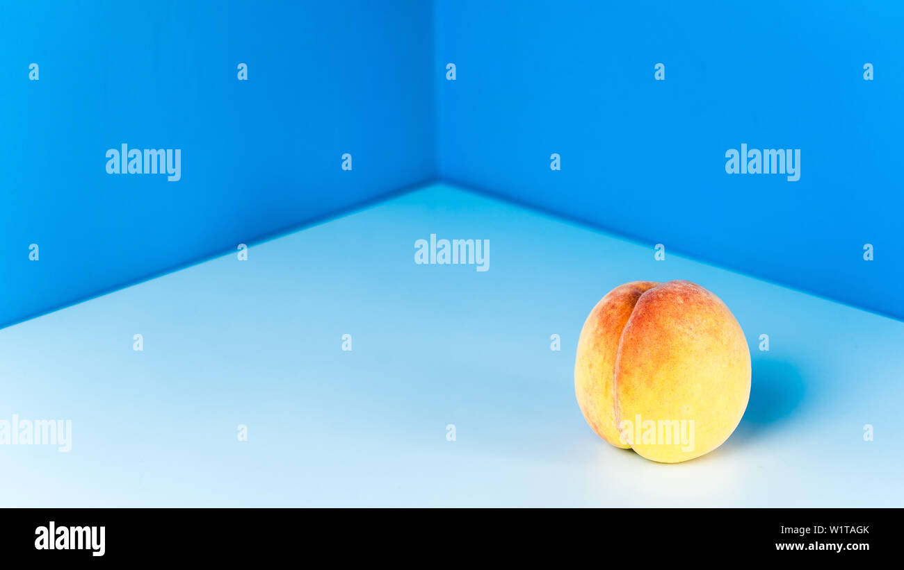 Ripe peach on a white table on a blue background. Table corner Stock ...