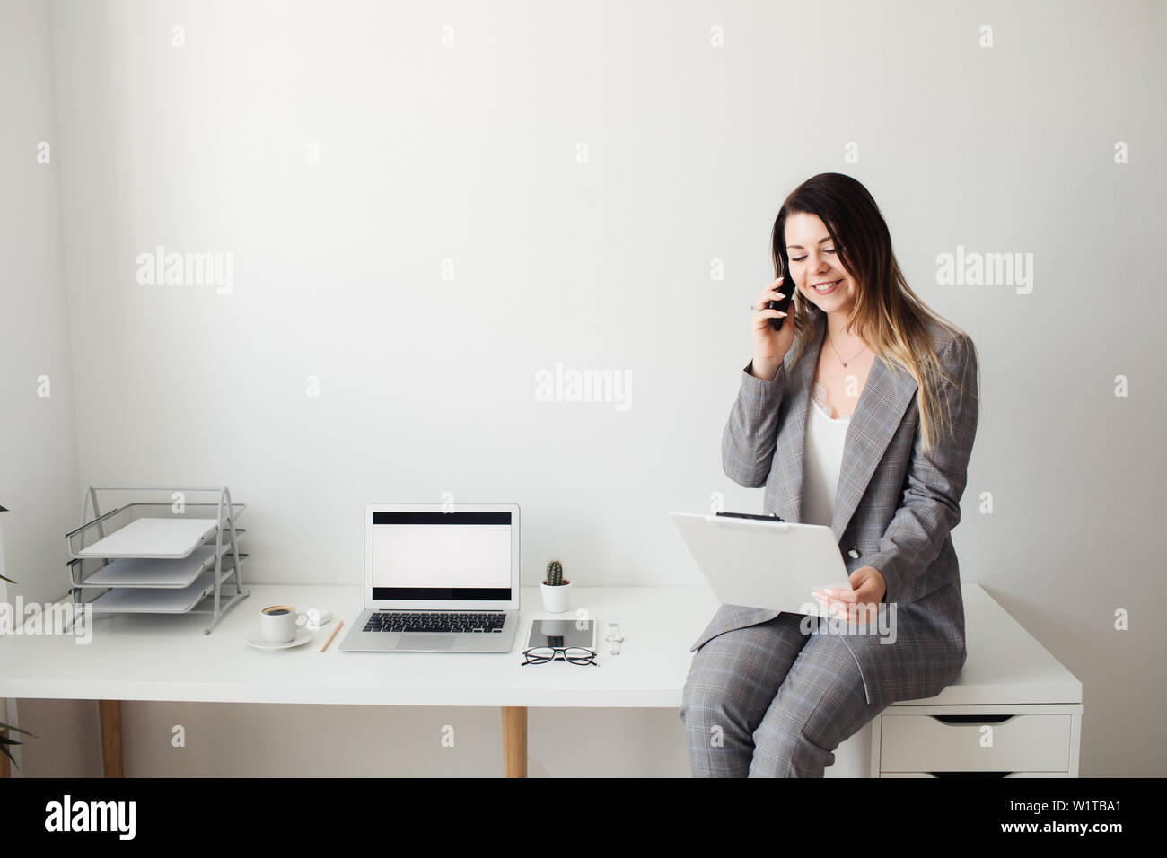 younger girl working in the office at the table Stock Photo - Alamy