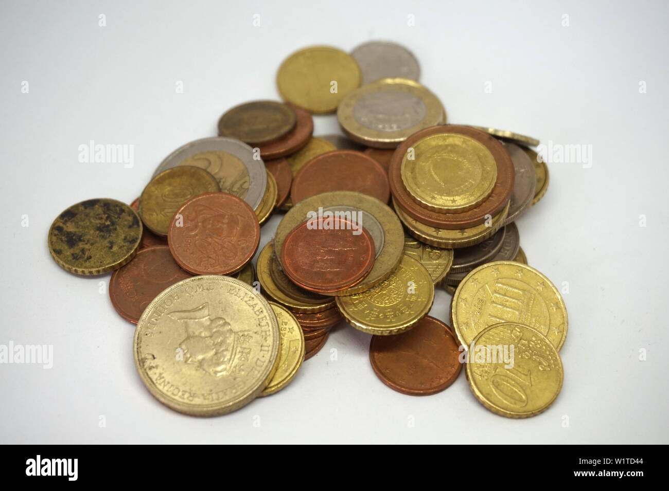 A pile of coins from different countries Stock Photo - Alamy