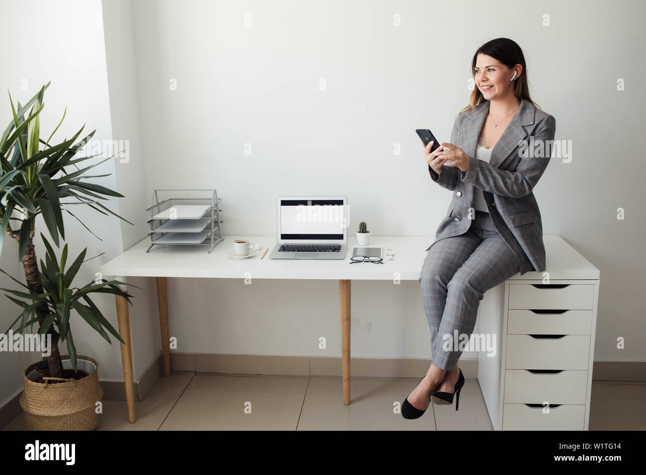 younger girl working in the office at the table Stock Photo - Alamy