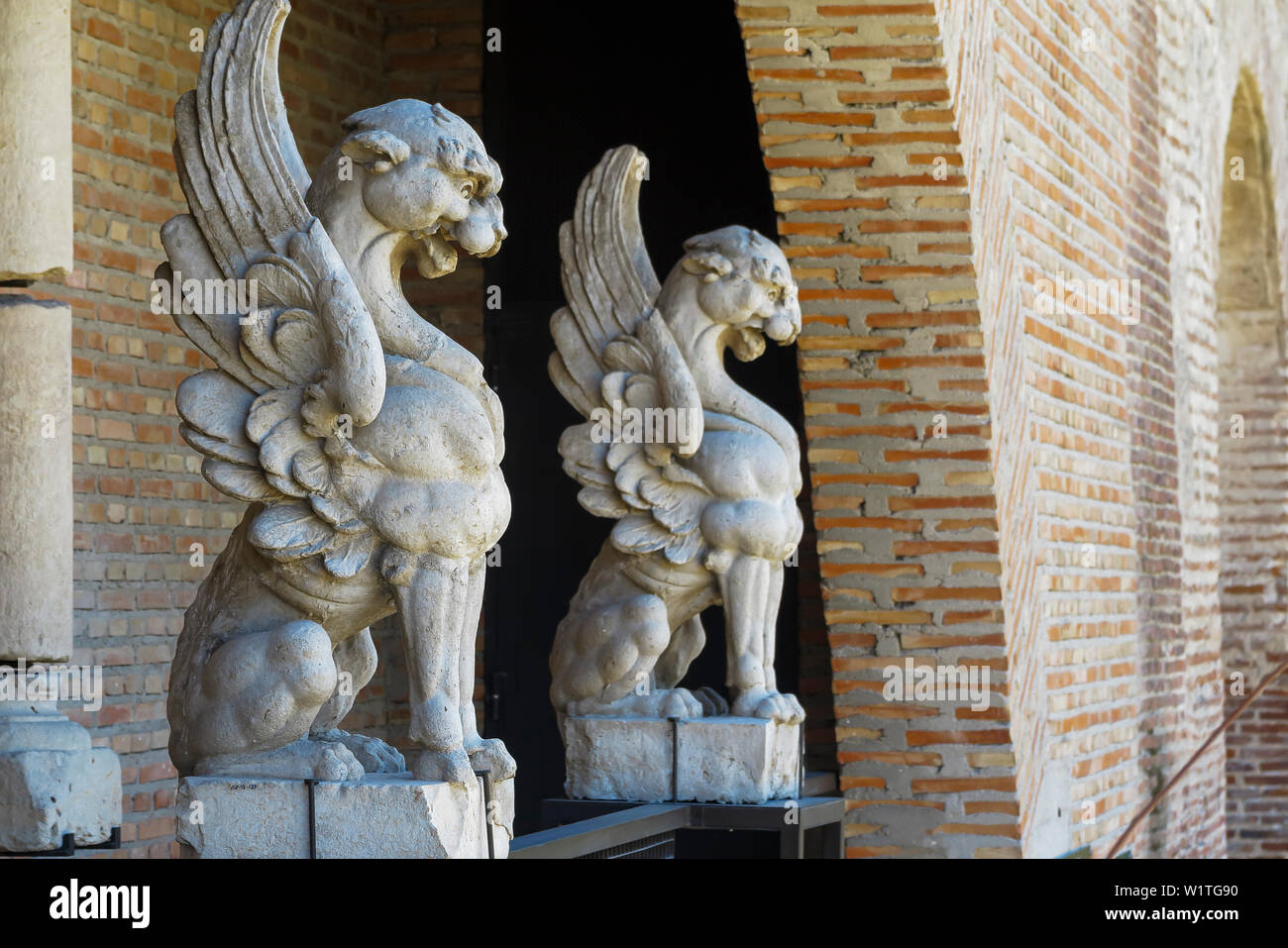 horizontal side view of two gargoyles carved in stone Stock Photo - Alamy