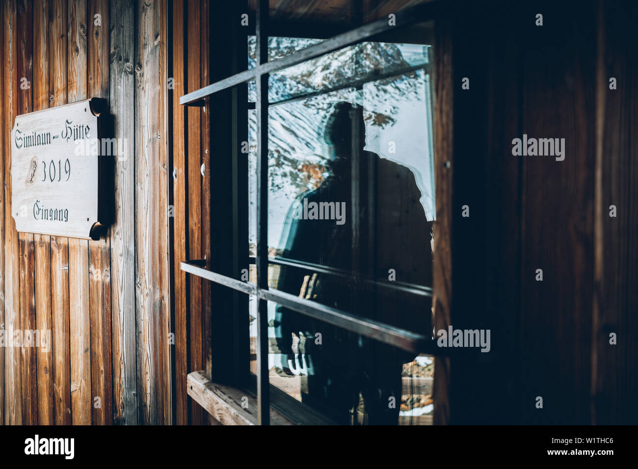 Mountaineer reflected in the window of the Similaun hut, E5 ...