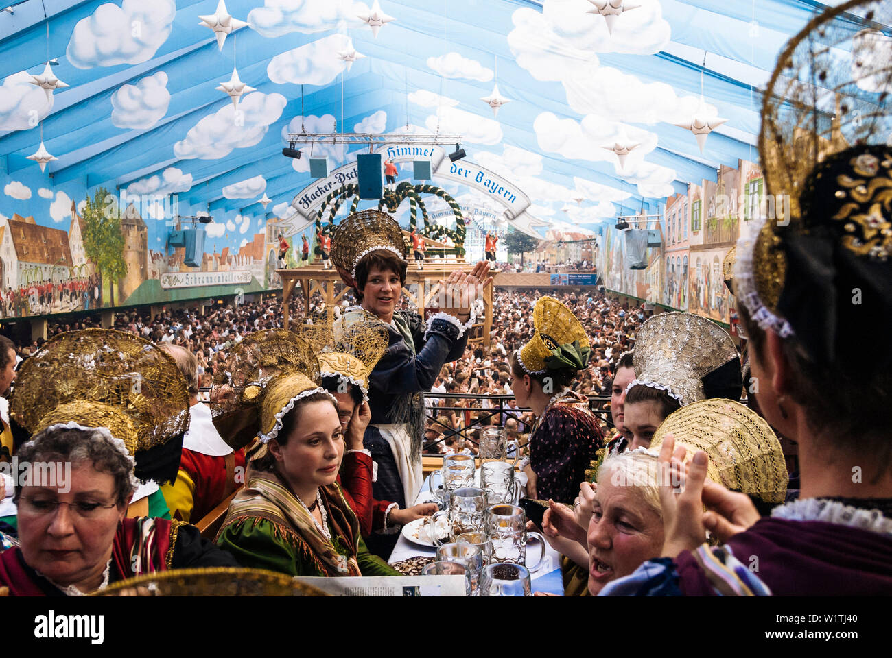 Women wearing the traditional golden hats, Oktoberfest, Munich, Bavaria ...