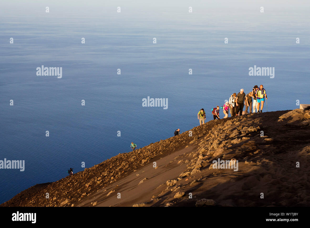 Tourists on the summit of Stromboli Volcano at sunset, Stromboli Island ...