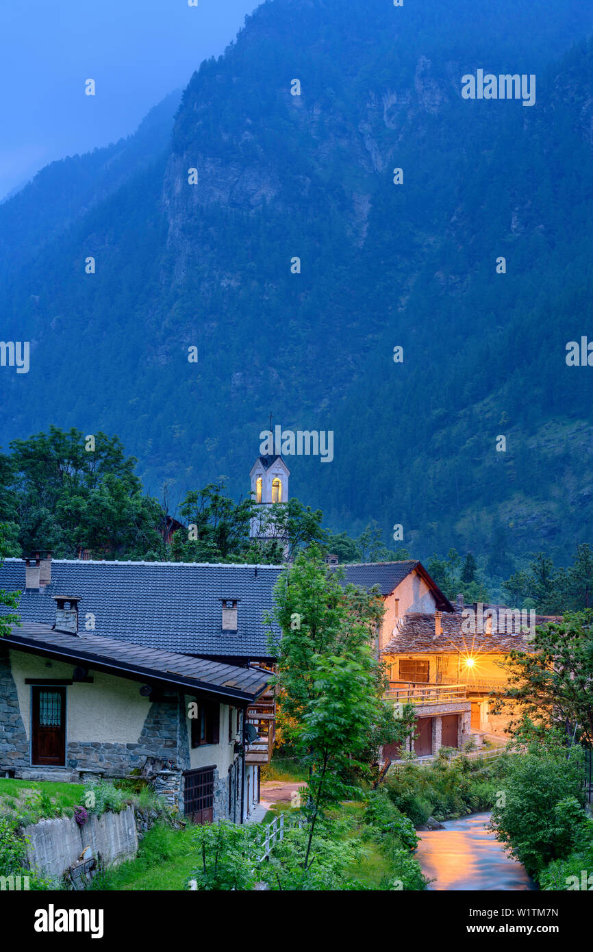 Alpine village with illuminated church and stream, Val Maira, Cottian ...