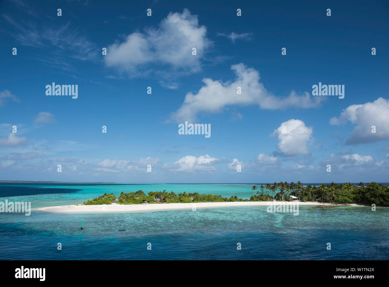 View of a narrow sand peninsula covered with trees and bushes and two ...