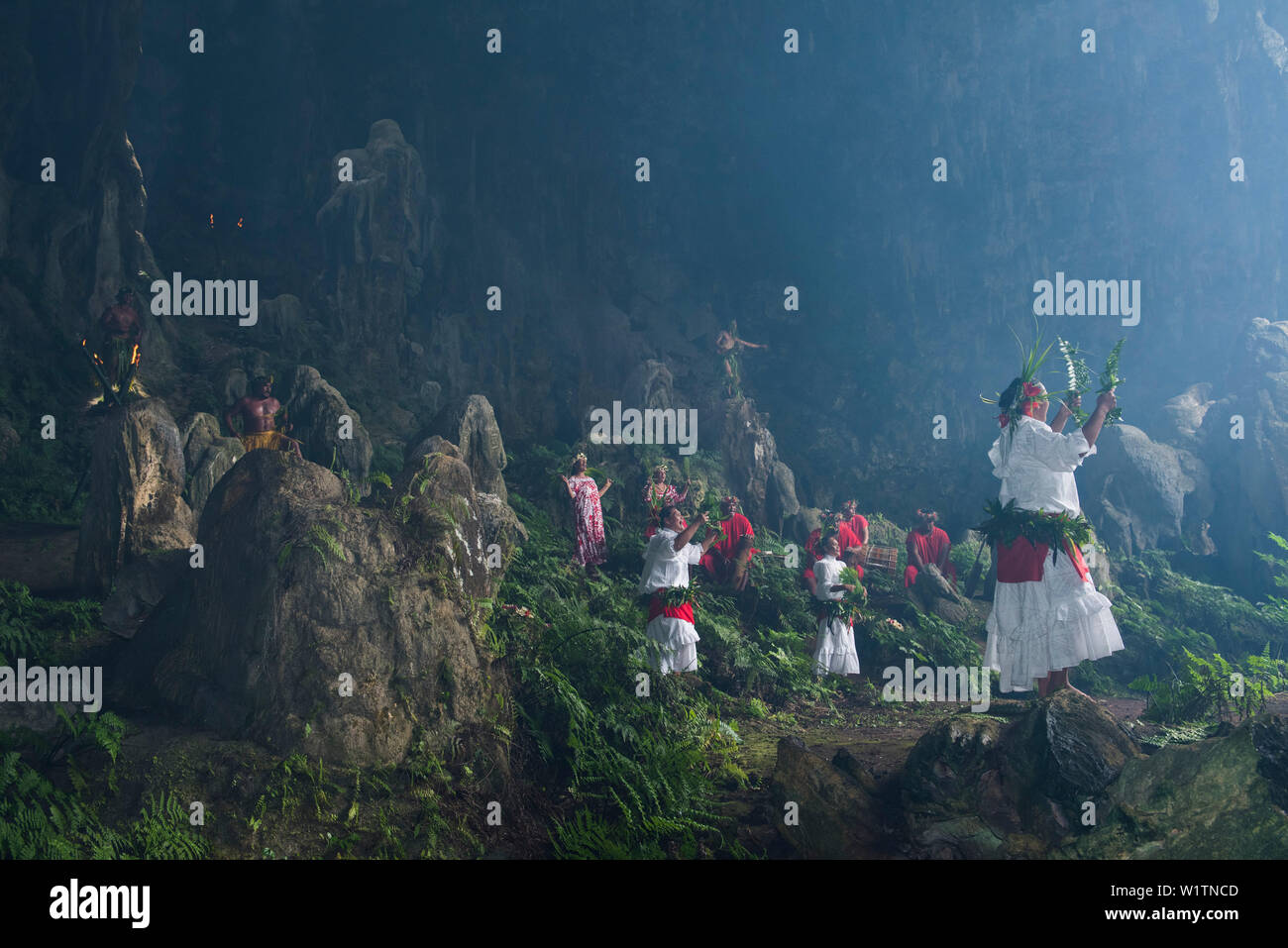 Locals, some in traditional costume, greet visiting tourists in the ...