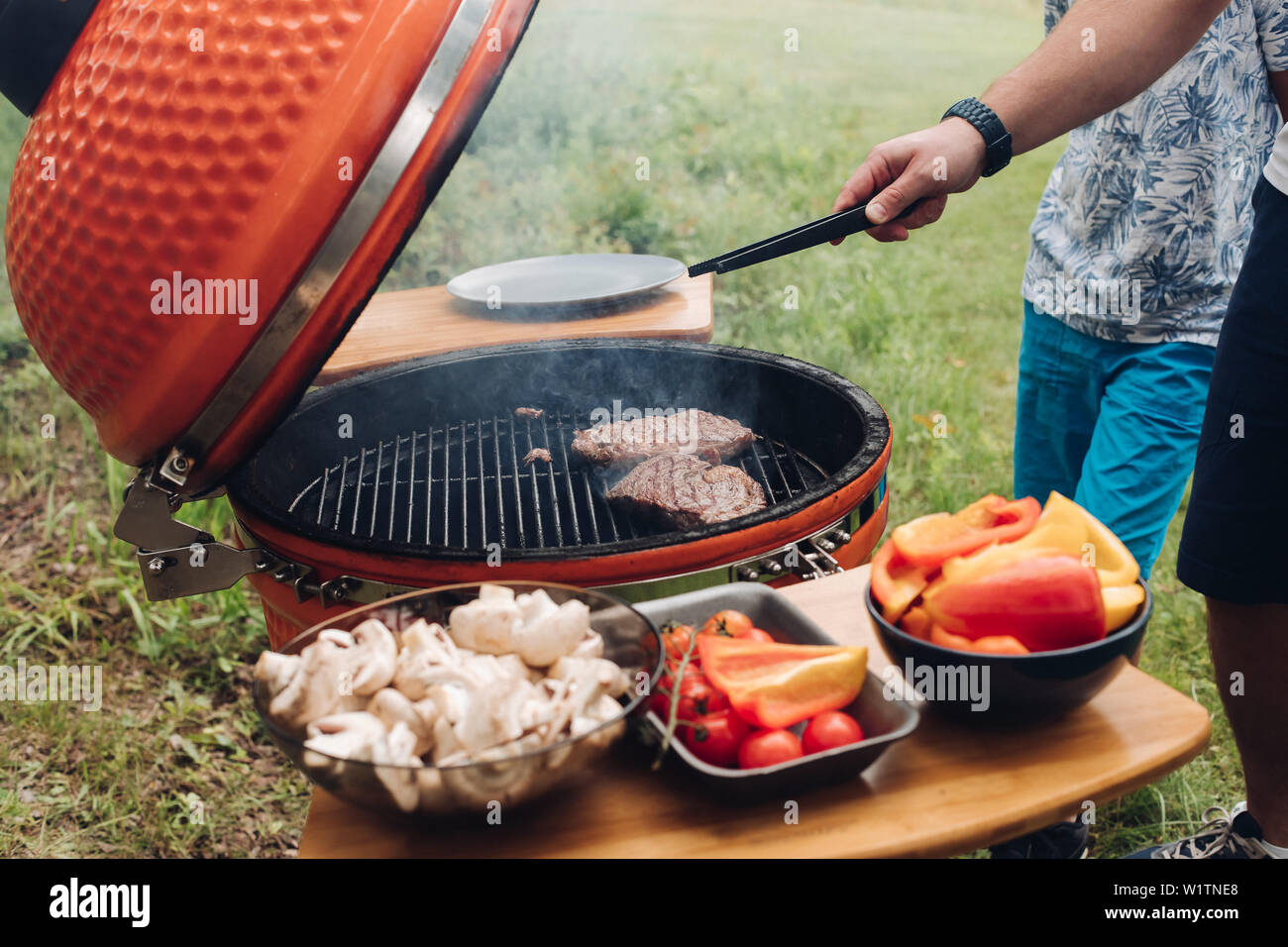 Closeup hand flipping grilled meat hi-res stock photography and images ...
