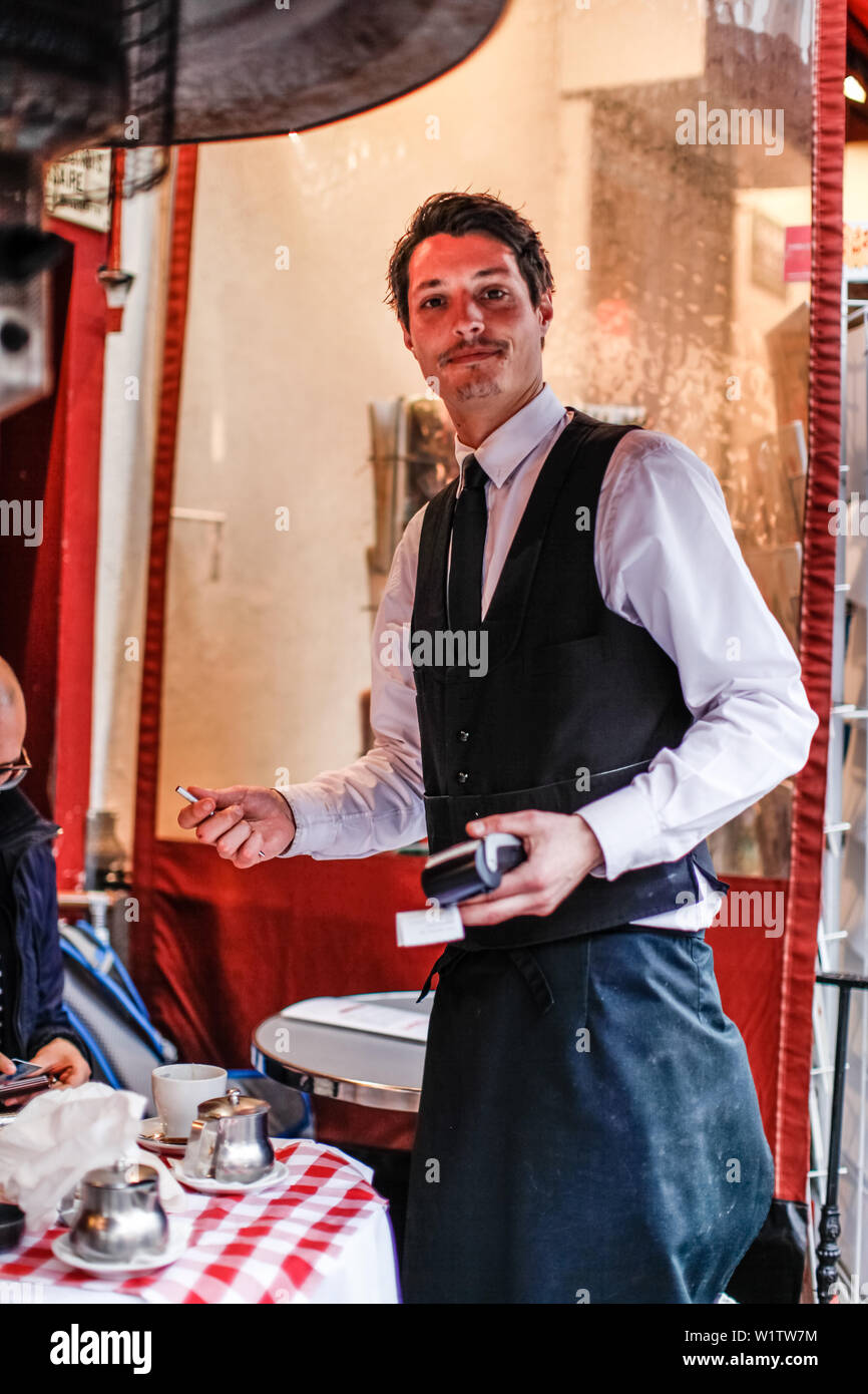 Waiter with the bill in one hand at the La Mère Catherine restaurant ...