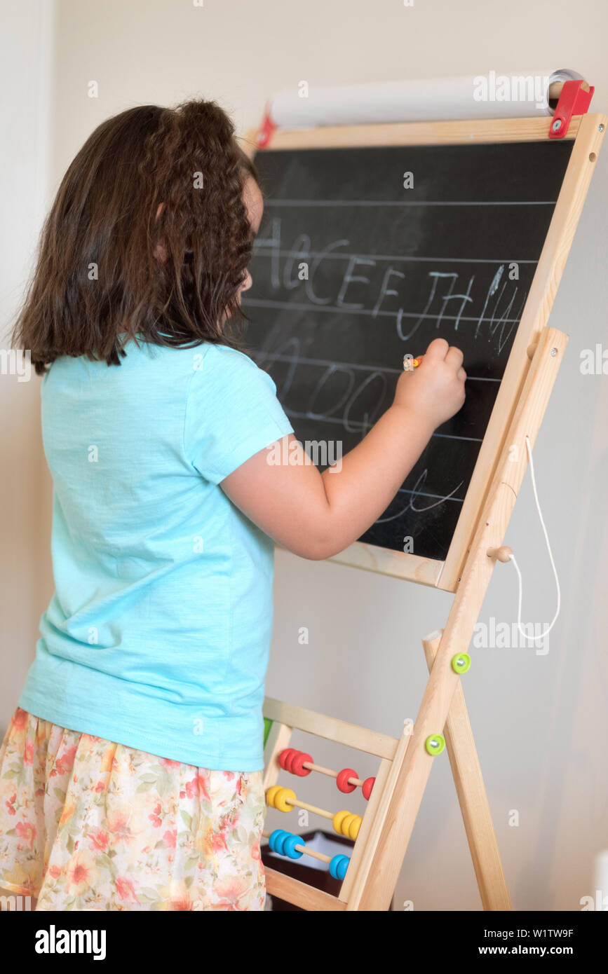 Child blackboard chalk write writing hi-res stock photography and ...