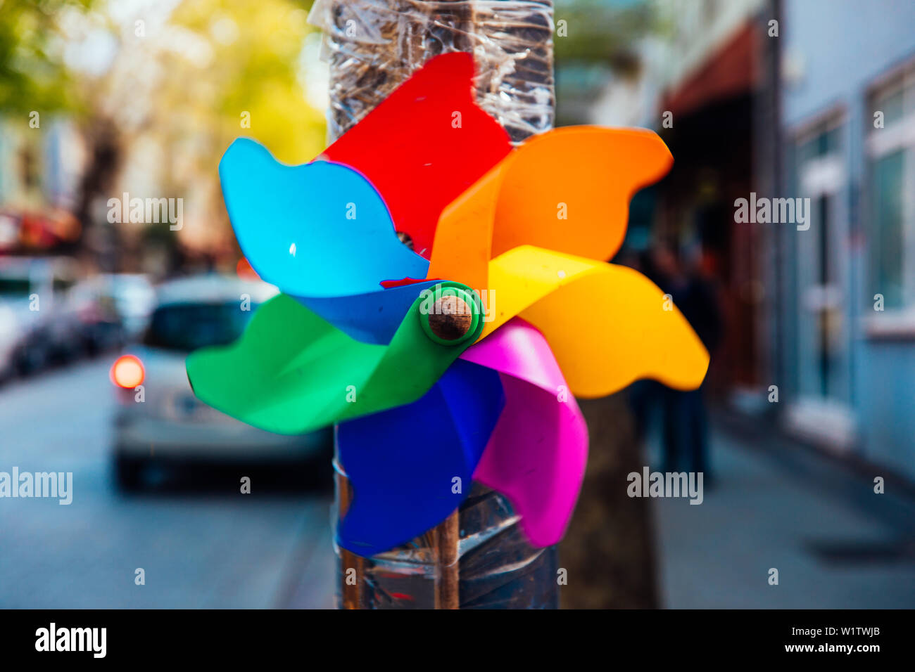 Colorful and rainbow colored paper windmill in street Stock Photo - Alamy
