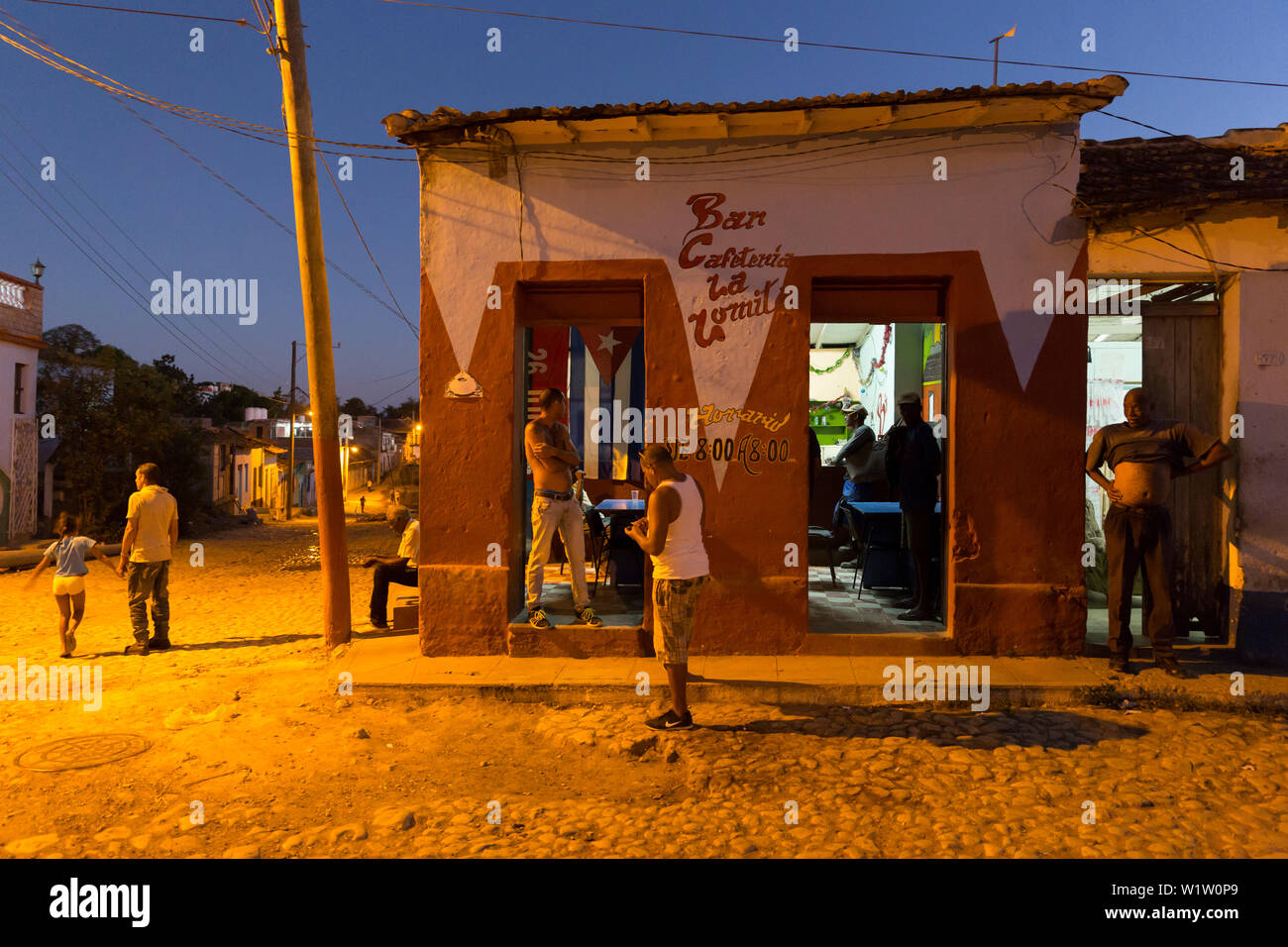 street scene at night in the city of Trinidad, bar, nightlife, family ...