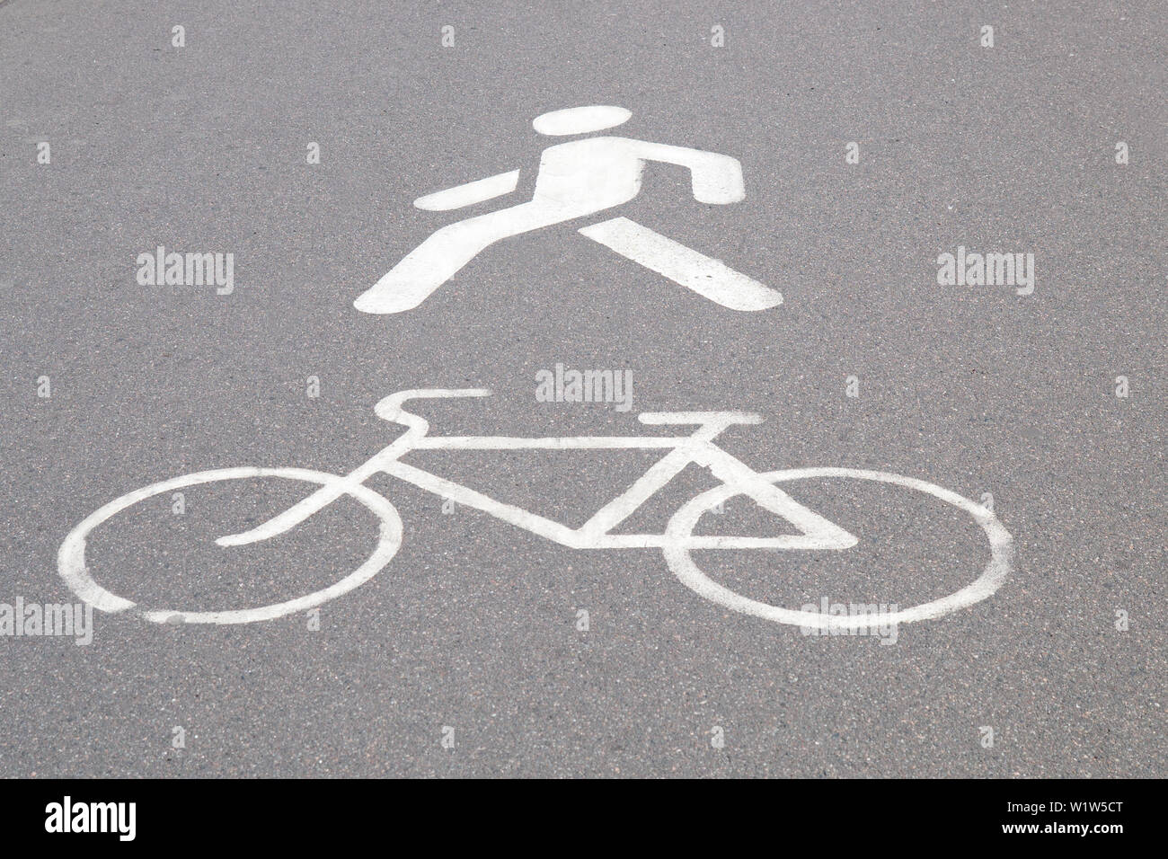 designation of a bicycle path and pedestrian walkway painted in white ...