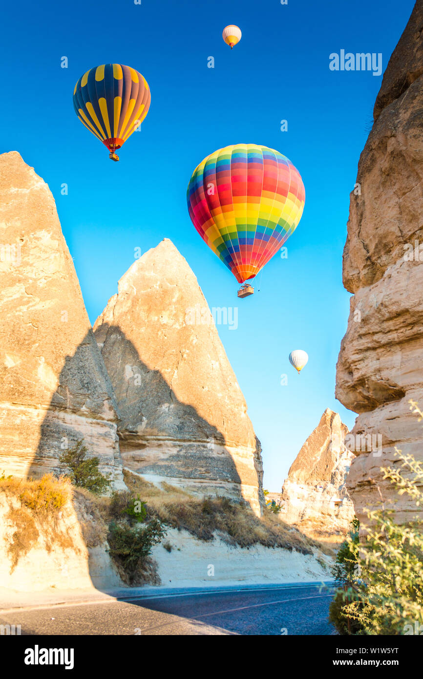 Colorful hot air balloons flying over at fairy chimneys in Nevsehir ...