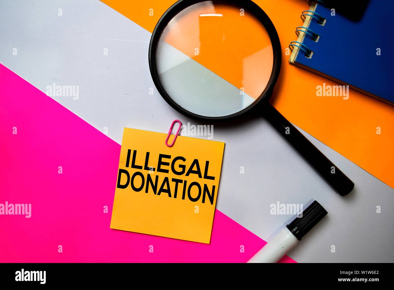 Illegal Donation text on sticky notes with color office desk concept ...