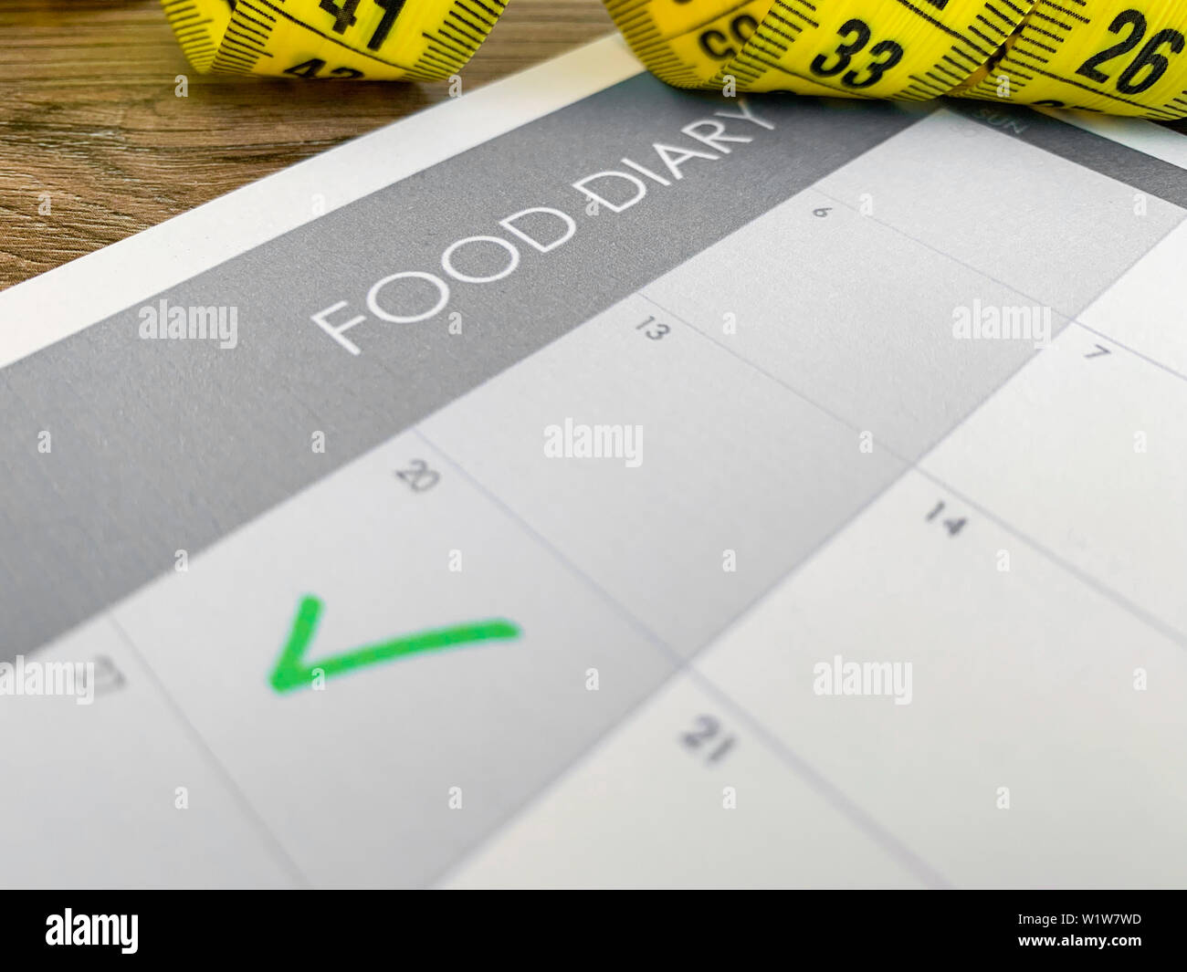 Diet plan concept. Measuring tape and diet plan on wooden background ...