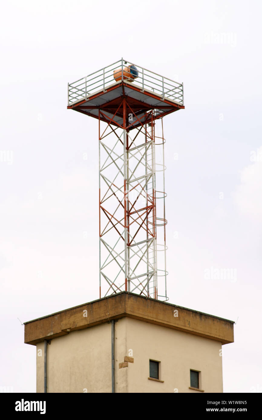 A disused watchtower with a floodlight on a disused airport area Stock ...