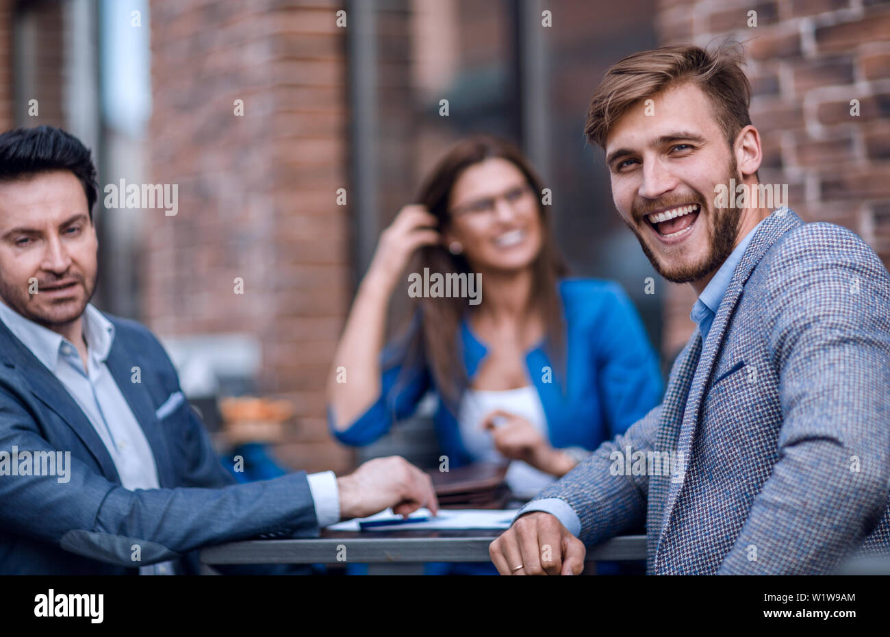 employees of the company sitting at a table in a street cafe Stock ...