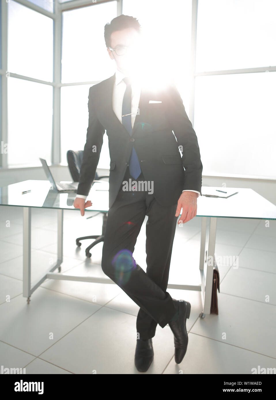 successful businessman standing near his Desk Stock Photo - Alamy