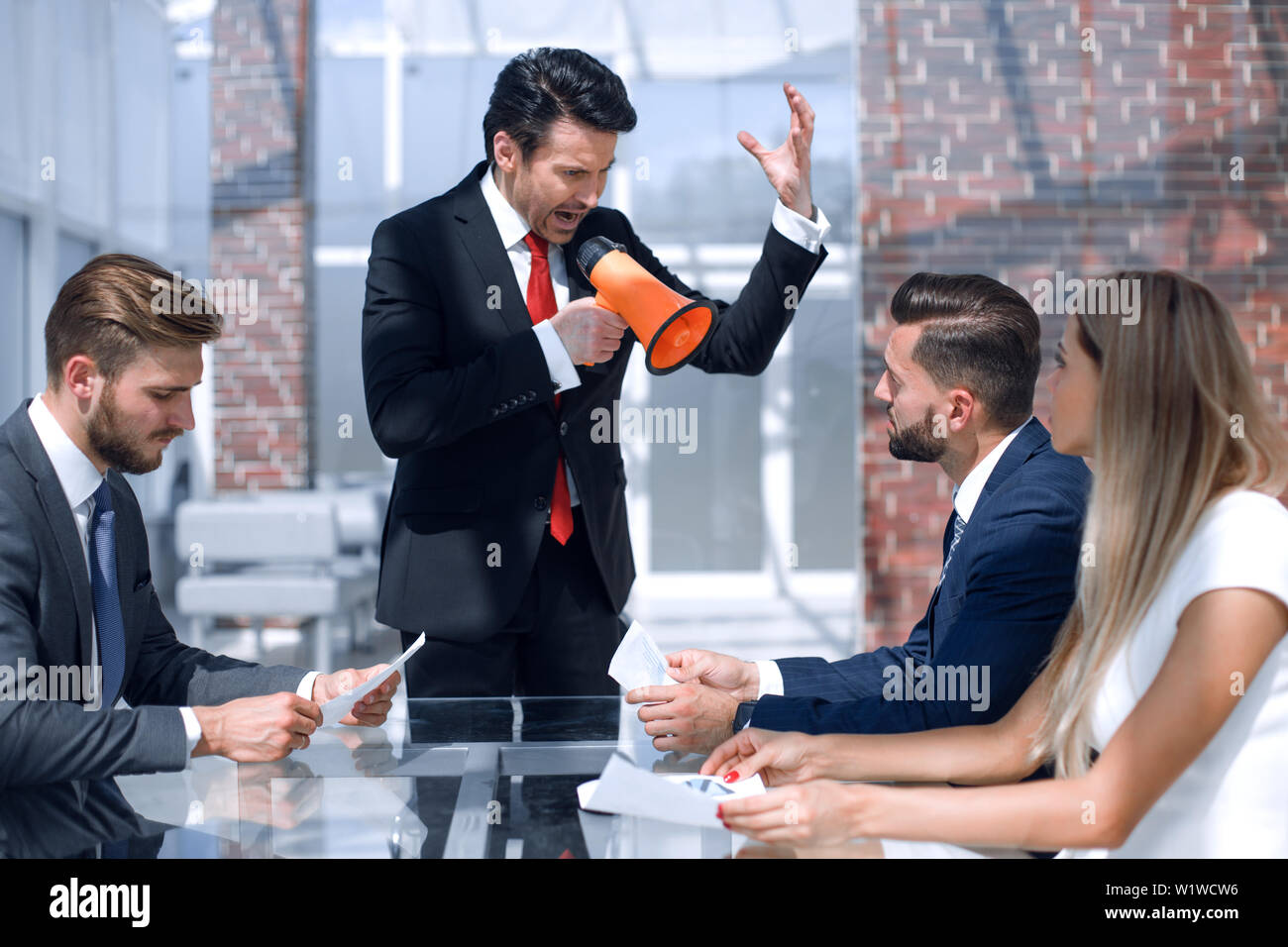 boss screams on the business team through a megaphone Stock Photo - Alamy