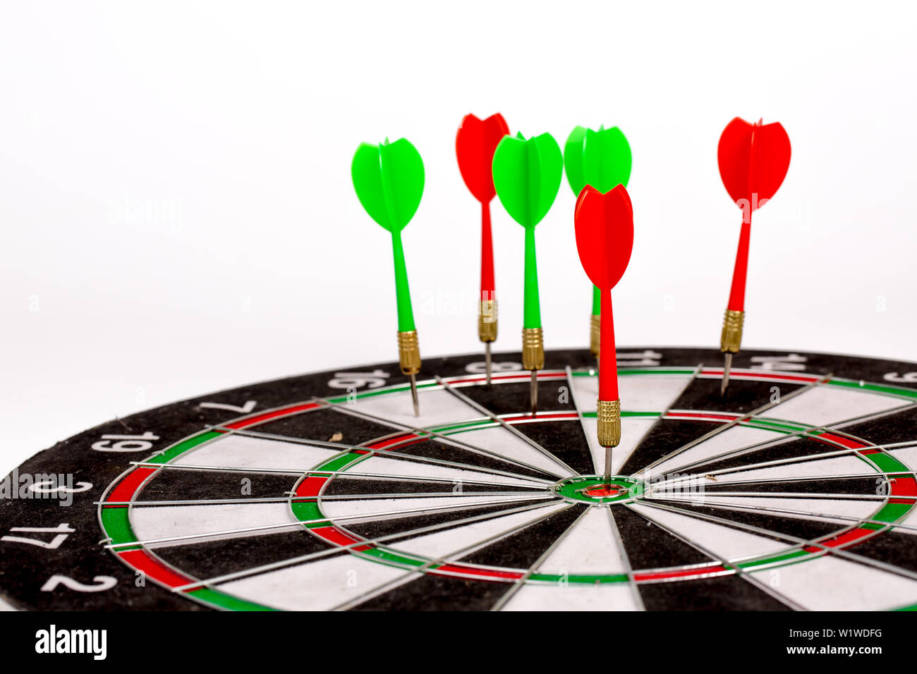 red darts hitting the center of target Stock Photo - Alamy
