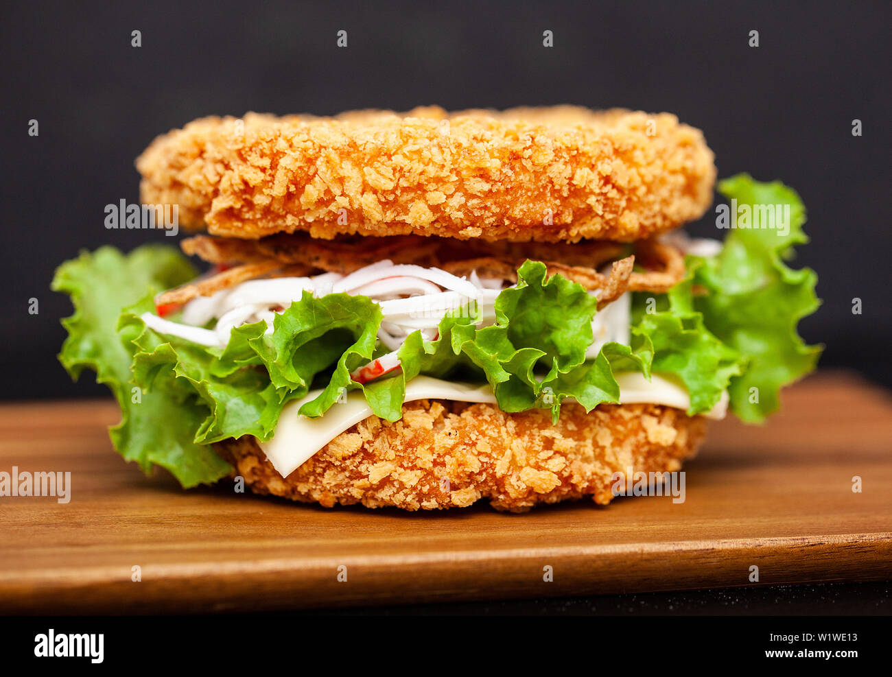 Sushi Burger with a variety of tasty ingredients on a dark background ...