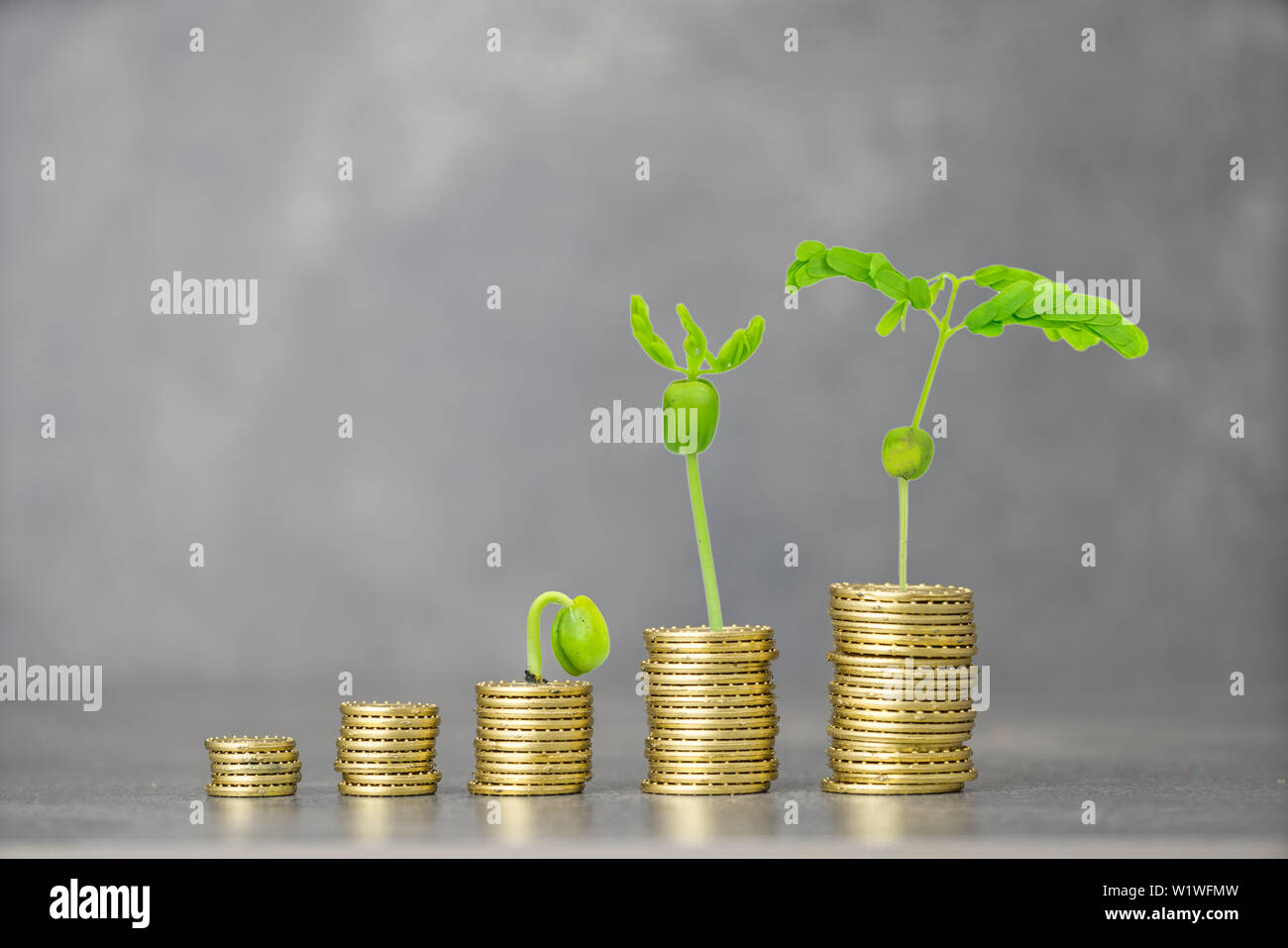 Close up gold coin stacking on dark background Stock Photo - Alamy